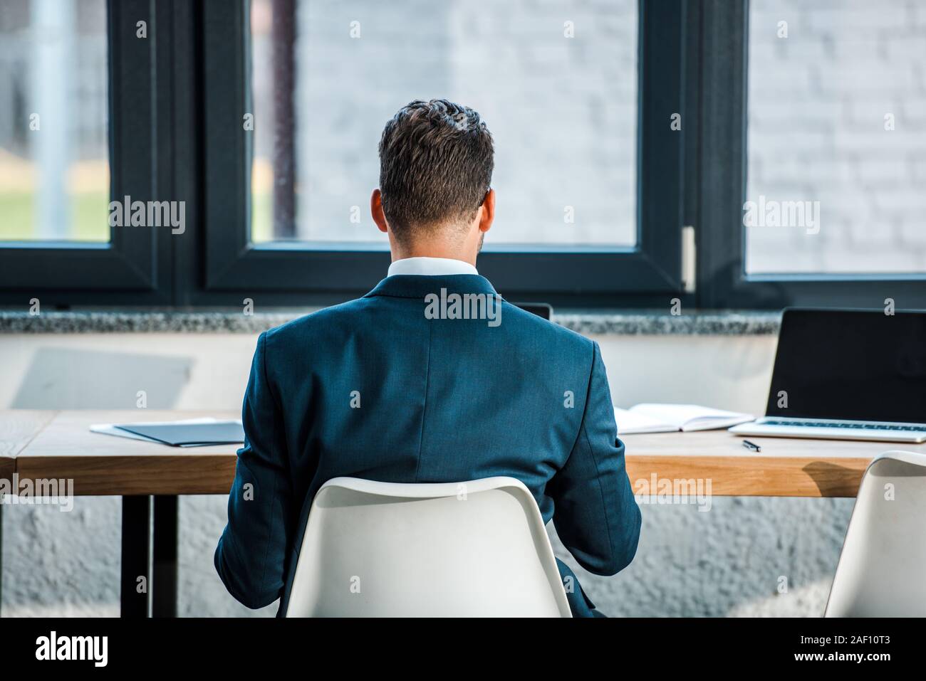 Back view of man sitting on workspace hi-res stock photography and ...