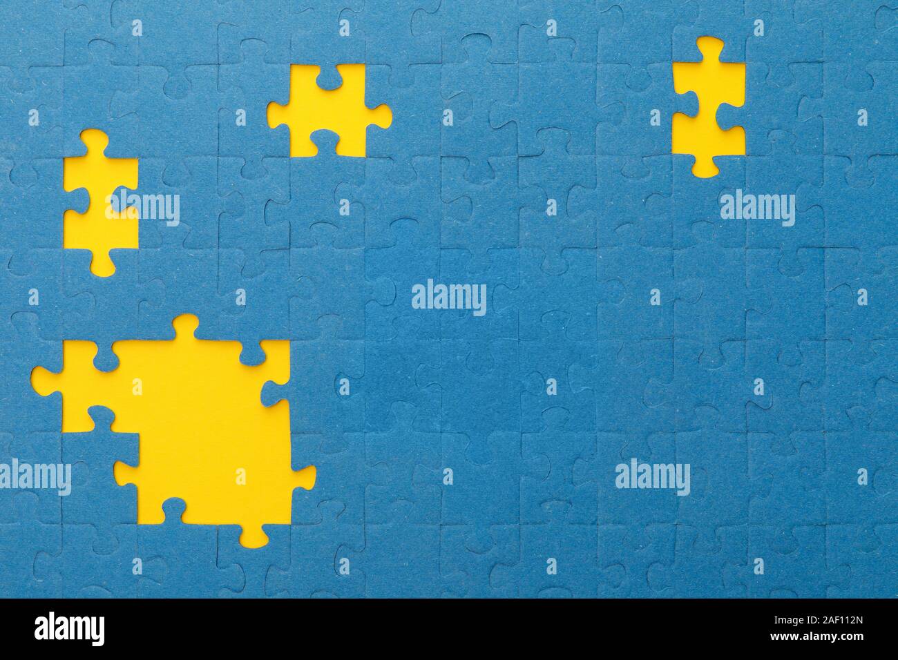 top view of blue jigsaw puzzle with yellow gaps Stock Photo - Alamy