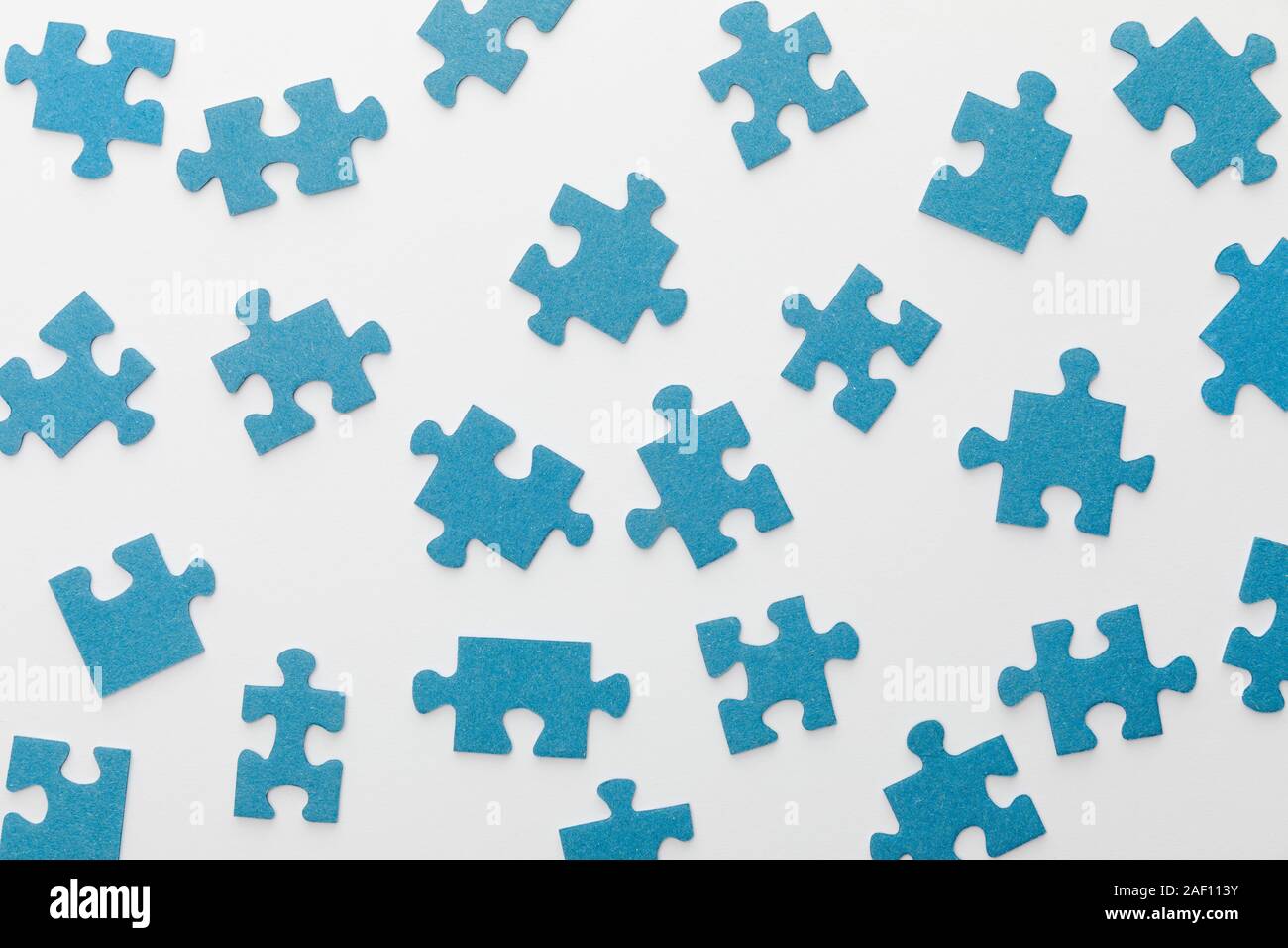 top view of scattered blue jigsaw puzzle on white background Stock ...