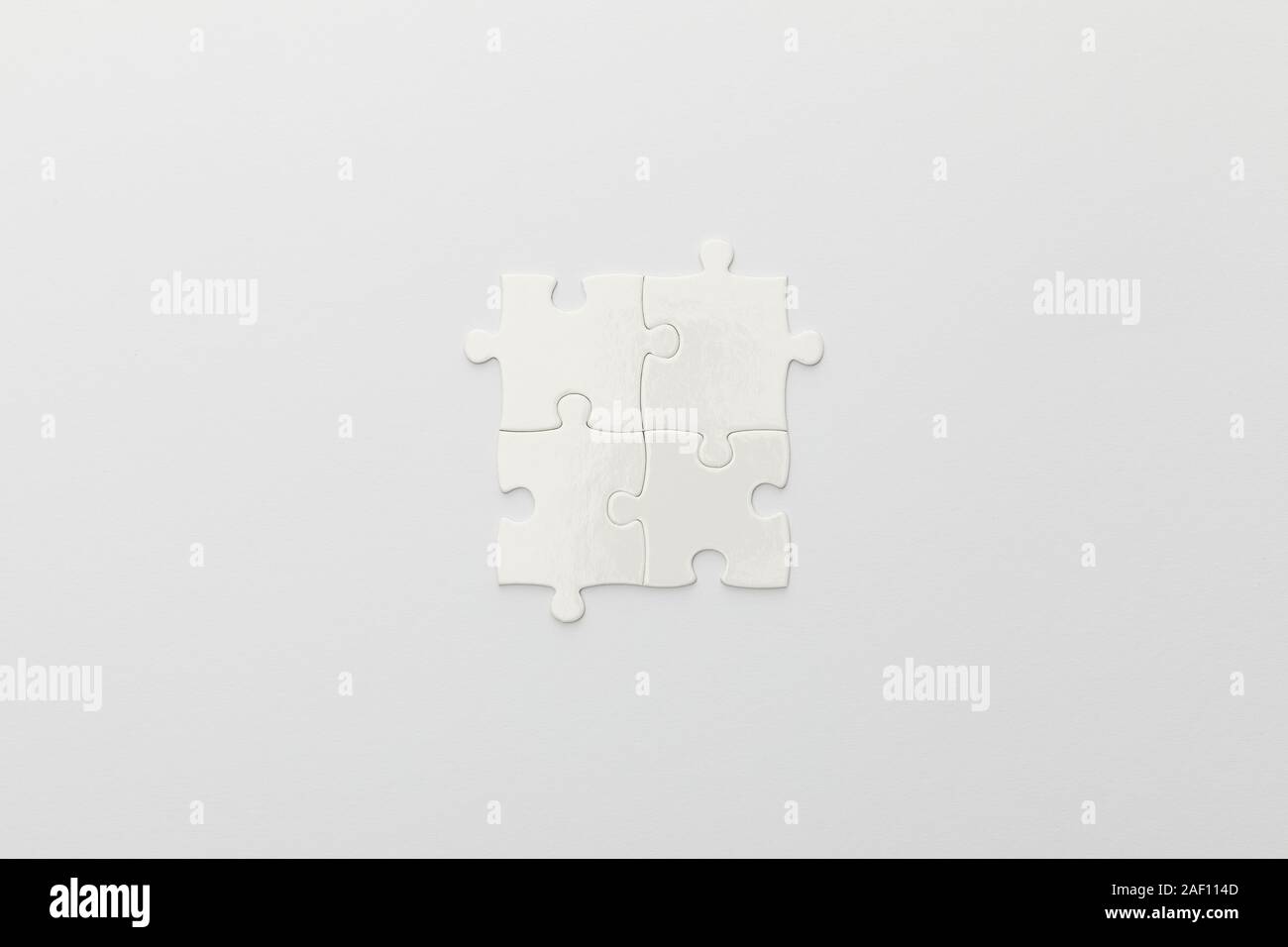 top view of completed part of jigsaw puzzle on white background Stock ...