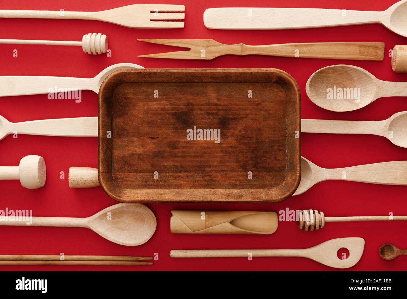 top view of empty rectangular wooden dish on red background with ...