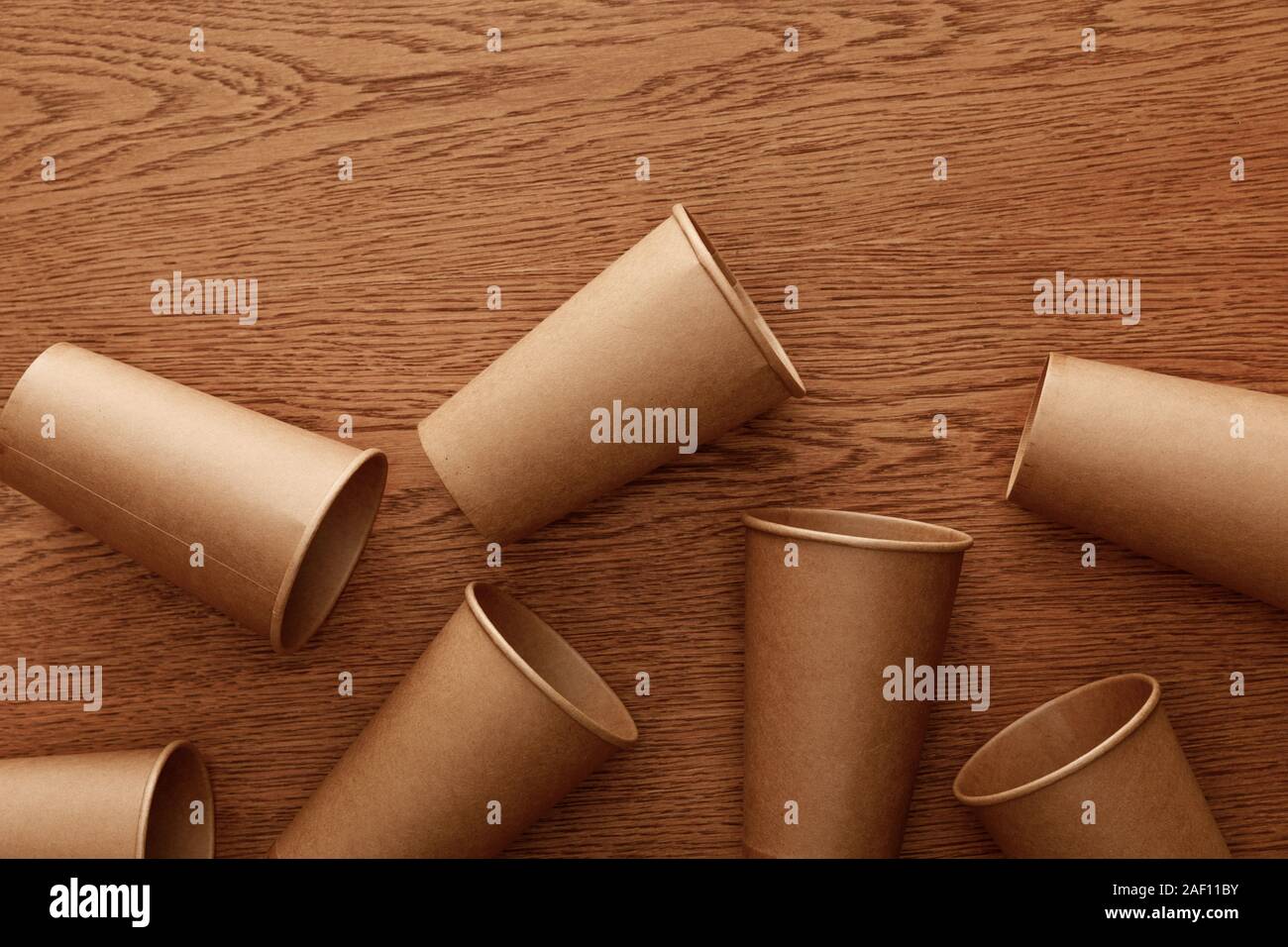 top view of empty paper cups on brown wooden background Stock Photo - Alamy