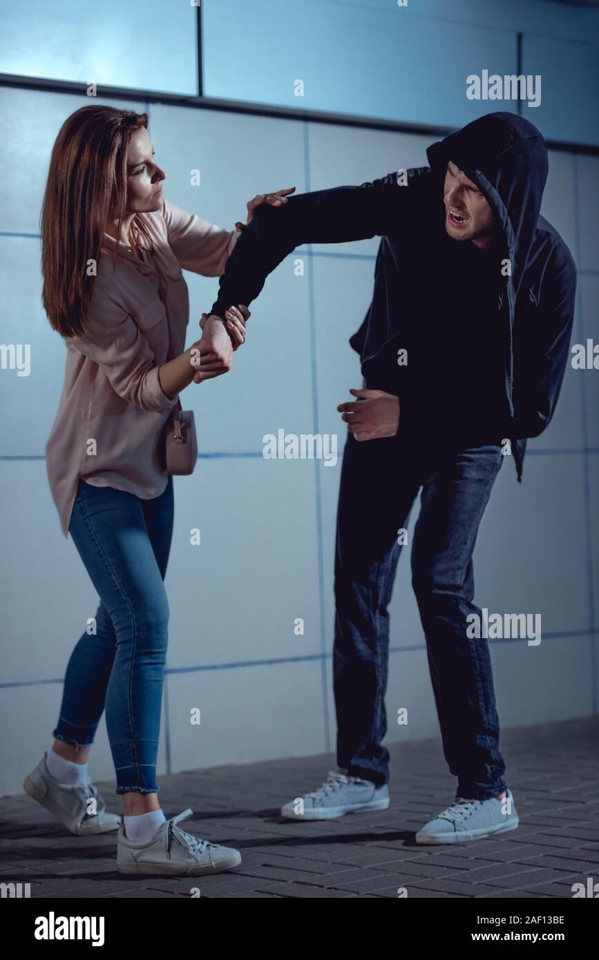 attractive woman fighting with thief in underpass Stock Photo - Alamy
