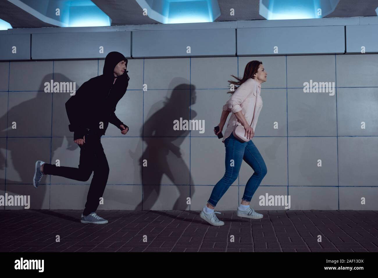 Woman running away danger hi-res stock photography and images - Alamy