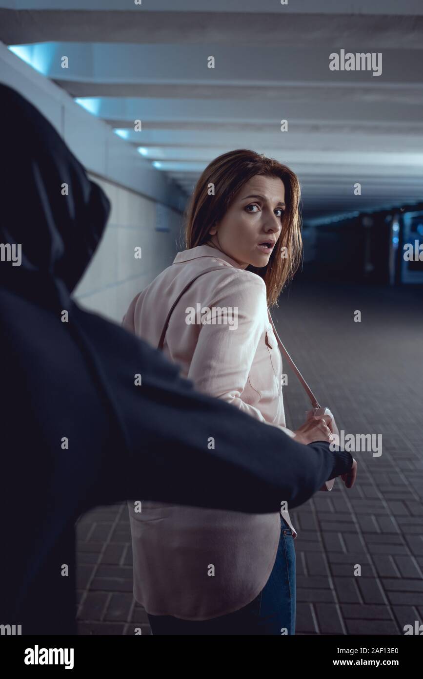 thief stealing bag from attractive woman in underpass Stock Photo - Alamy