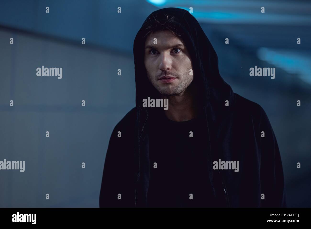 handsome thief in black hoodie in underpass Stock Photo - Alamy