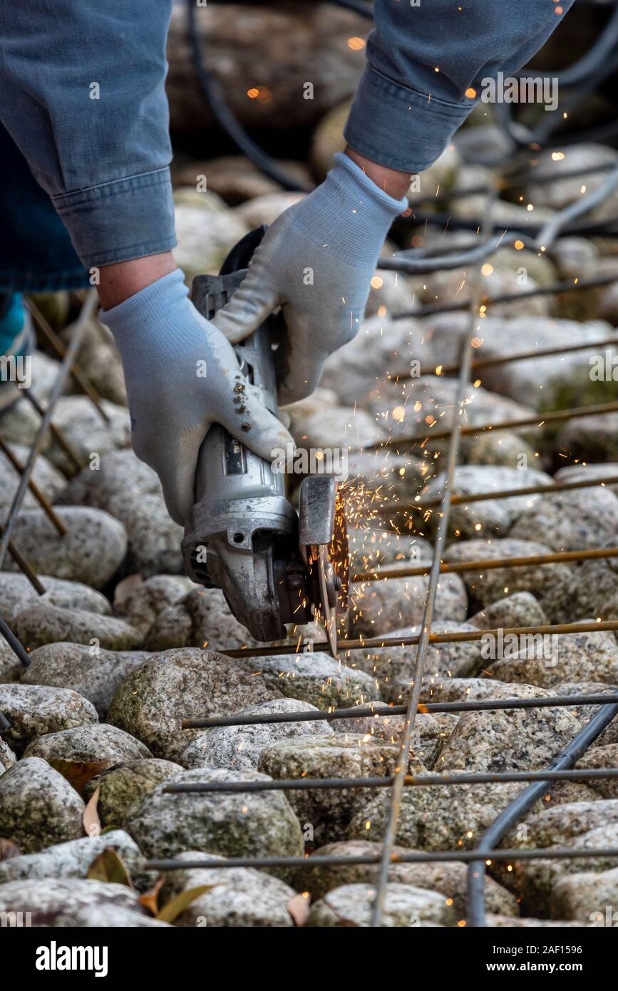 Metal worker cutting steel with a radial saw Stock Photo - Alamy