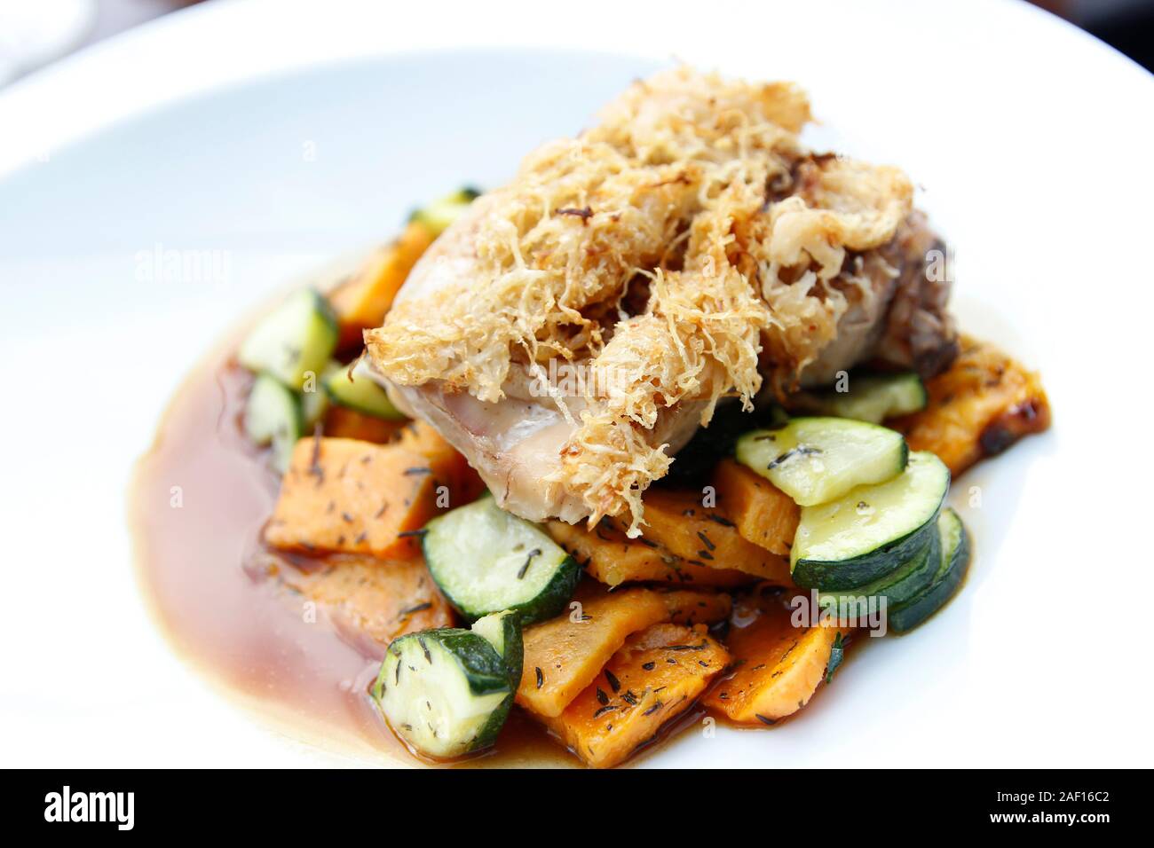 Braised chicken leg, Mediterranean flavoured vegetables, celery chips ...