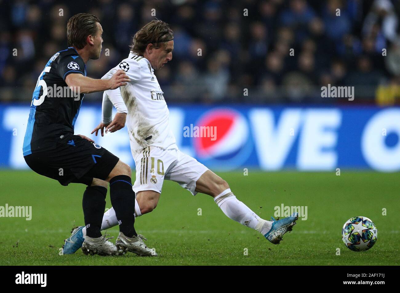 Brugge, Belgium. 11th Dec, 2019. Luka Modric (R) of Real Madrid passes ...