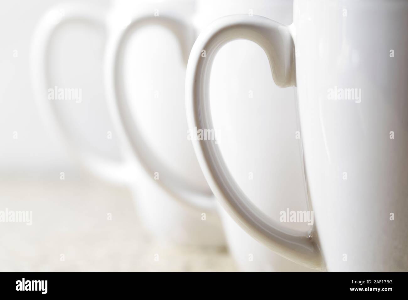 coffee cups aligned on a counter top Stock Photo - Alamy
