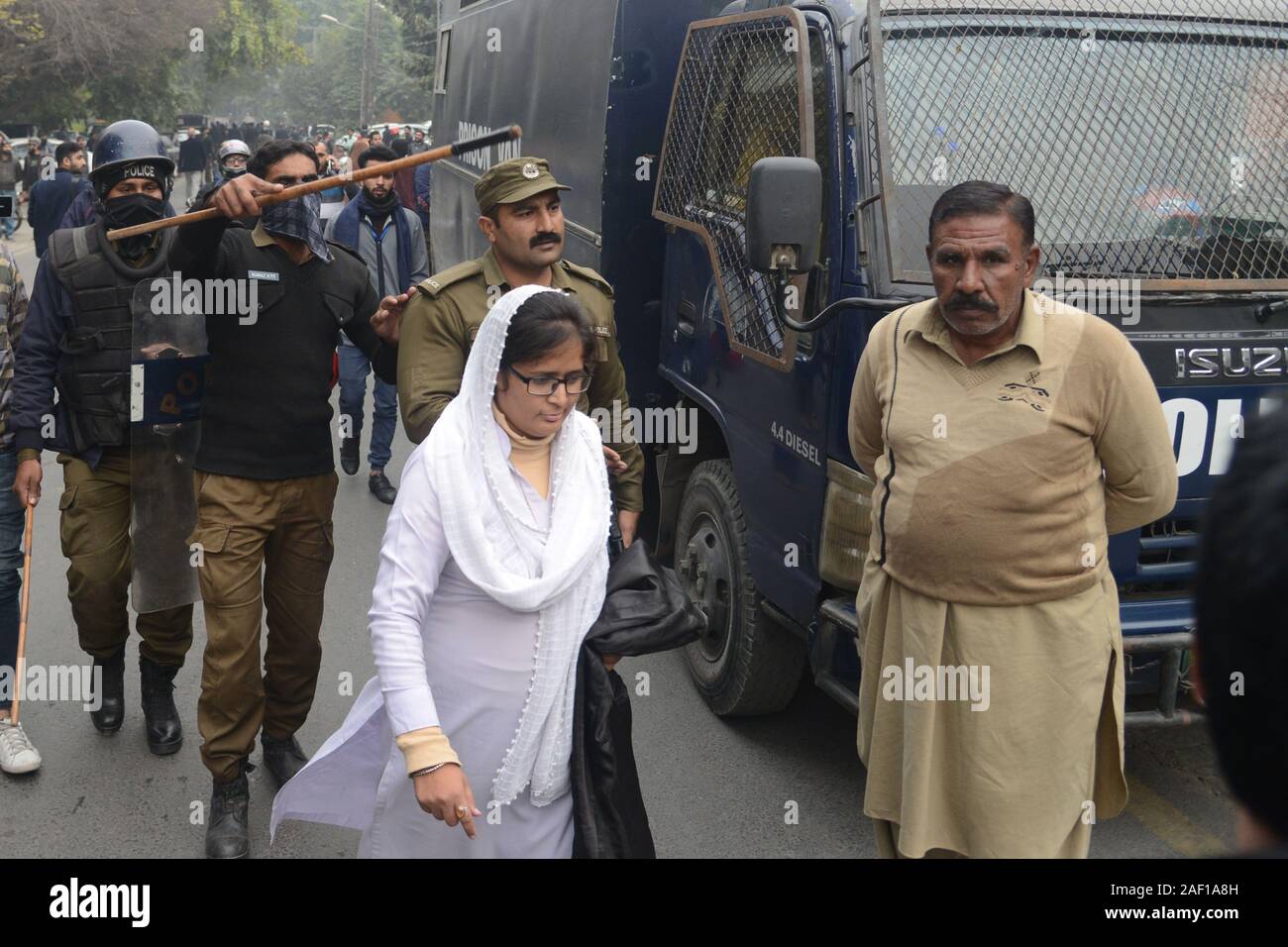 Pakistani Police officers detain angry lawyers (C in white shirt ...