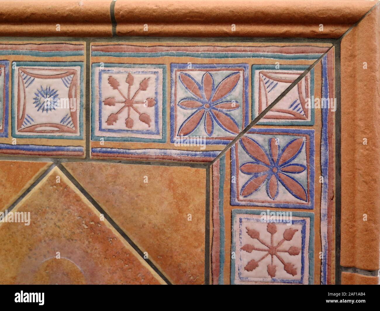 Closeup of Wall tiled with colorful ceramic tiles in village in ...