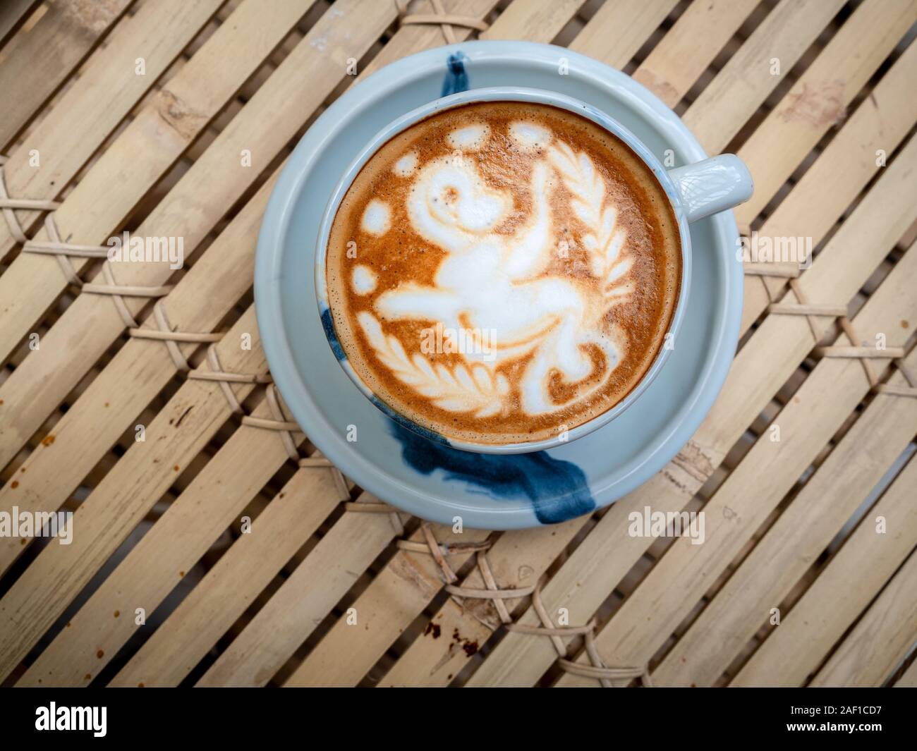 Hot coffee cup with latte art. Coffee with circus monkey sitting on ...