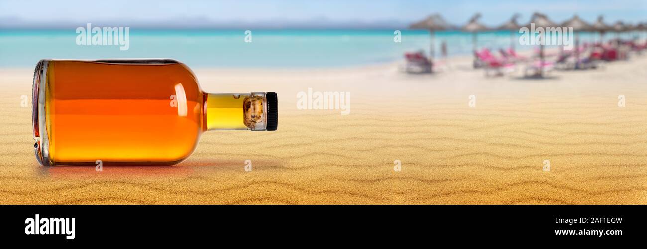 Holiday fun concept. Bottle of rum on the beach background Stock Photo ...