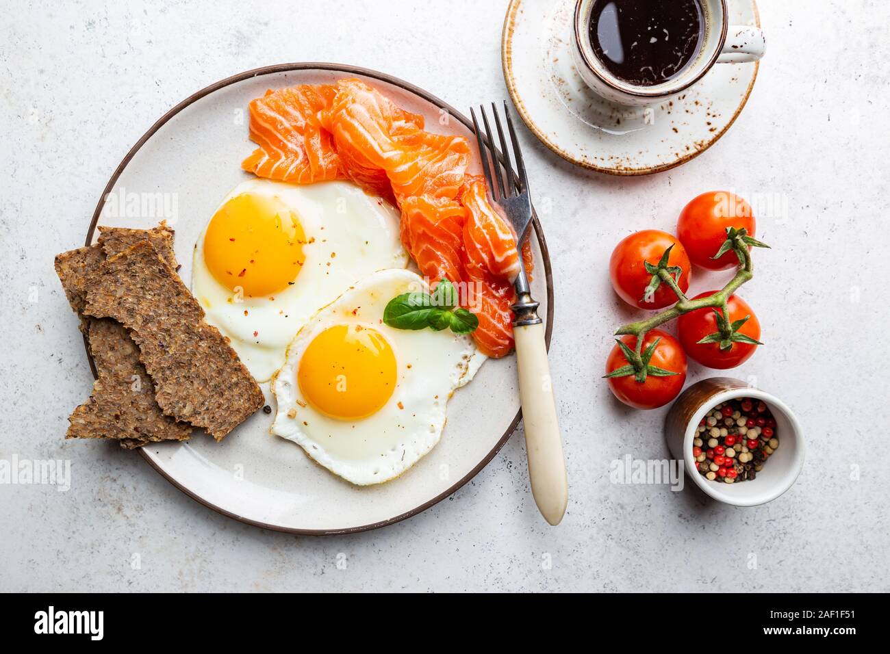 Top view of healthy breakfast with fried eggs and smoked salmon in a ...
