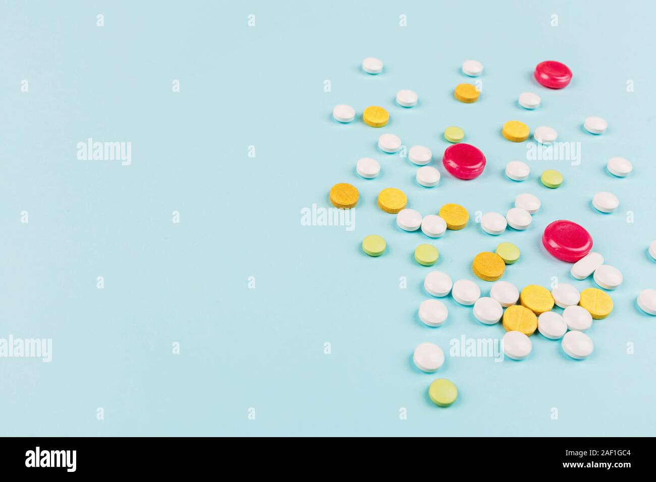 Colorful pills on a pastel blue background. Flat lay, top view ...