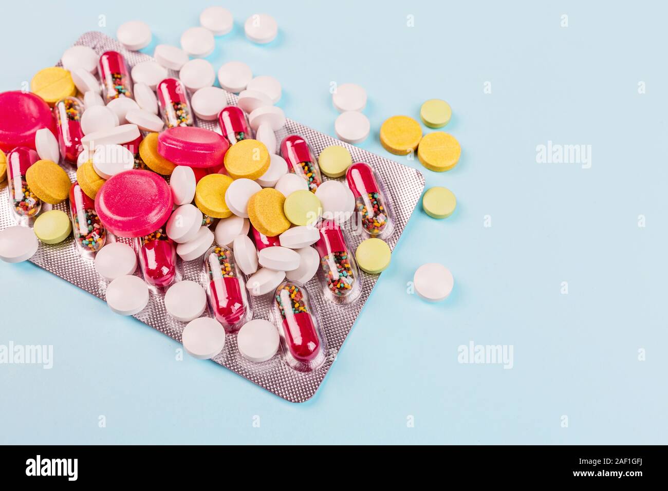 Colorful pills on a pastel blue background. Flat lay, top view ...