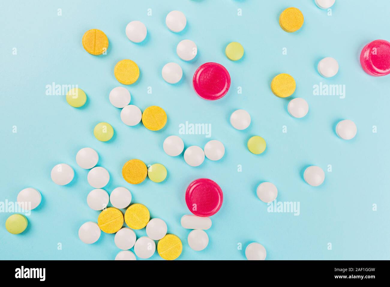 Colorful pills on a pastel blue background. Flat lay, top view ...