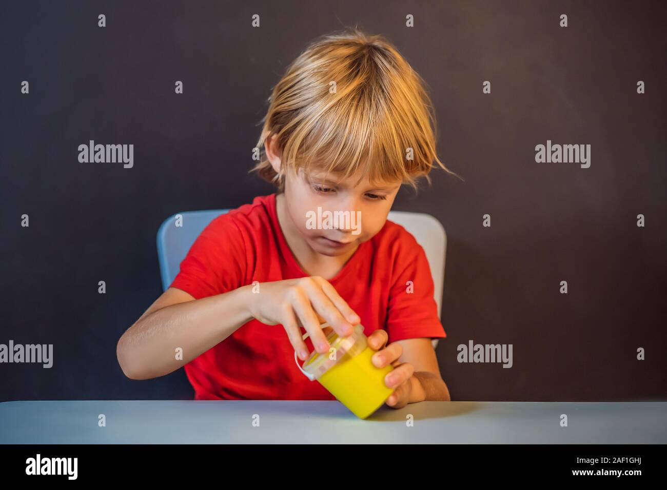 Boy playing hand made toy called slime. Child play with slime. Kid ...
