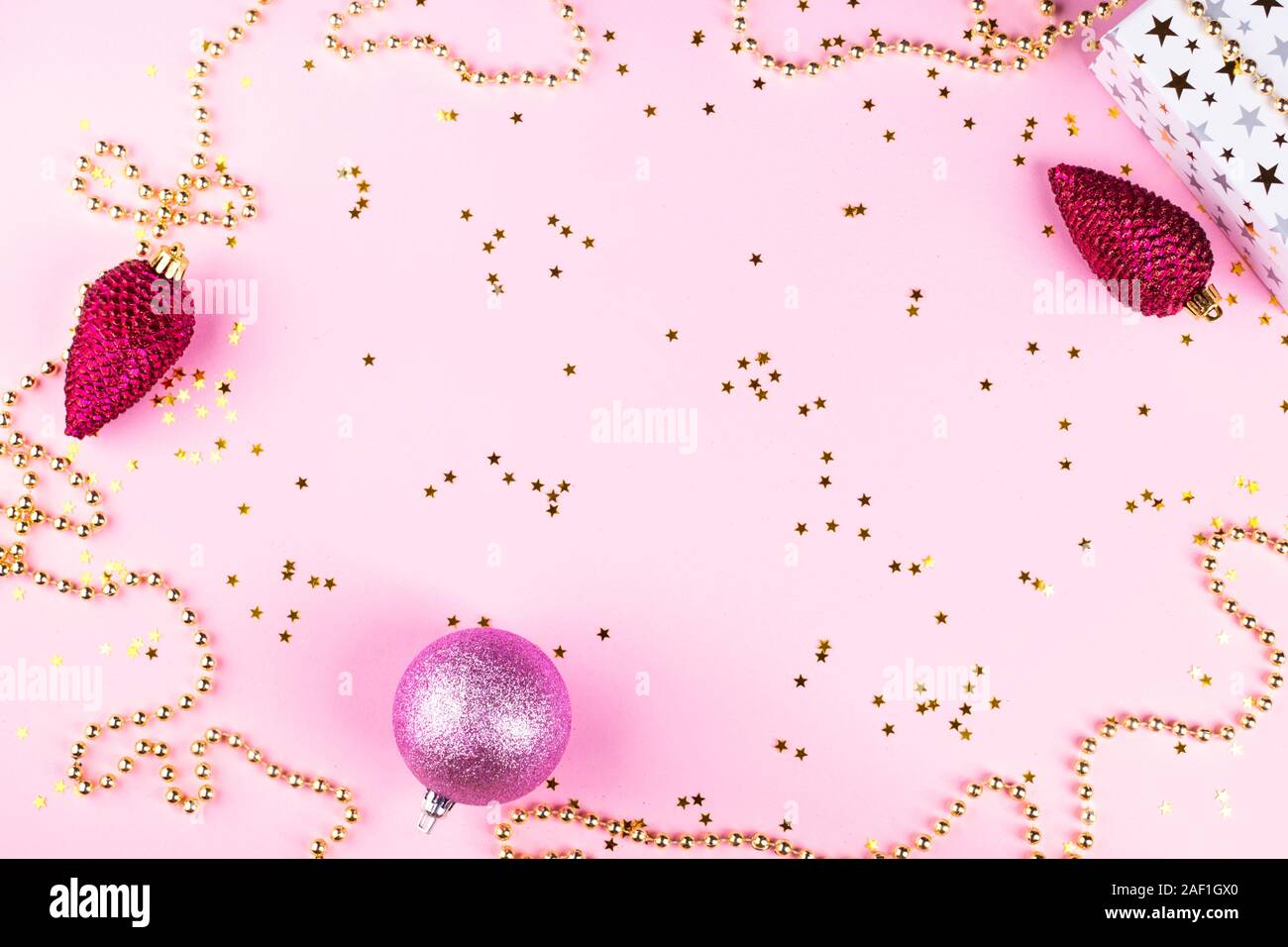 Christmas festive ornament frame with pink ornament. Flat lay frame on ...