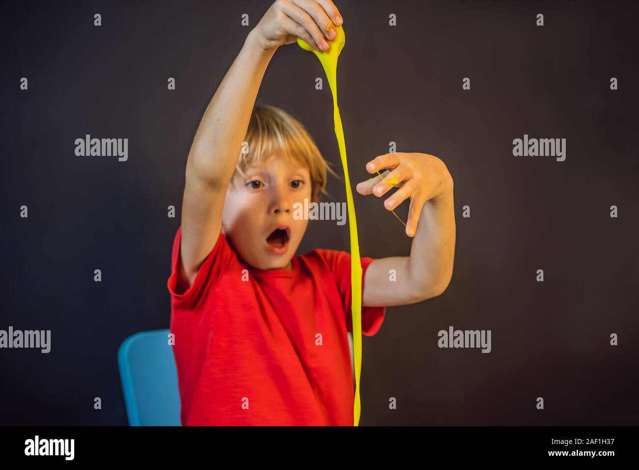 Boy playing hand made toy called slime. Child play with slime. Kid ...