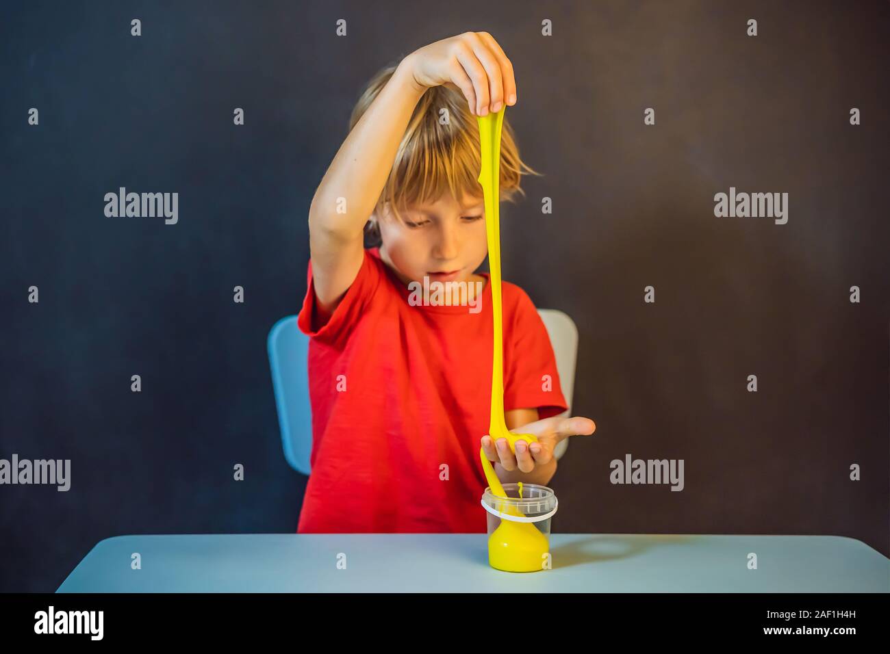 Boy playing hand made toy called slime. Child play with slime. Kid ...
