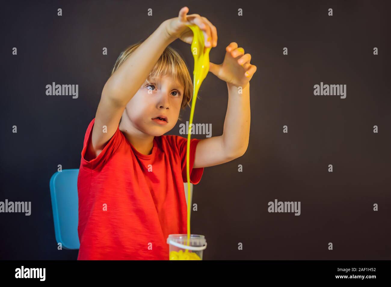 Boy playing hand made toy called slime. Child play with slime. Kid ...