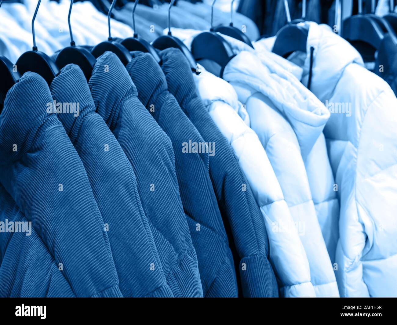 Classic blue toned fast fashion jackets on hangers in a store Stock ...