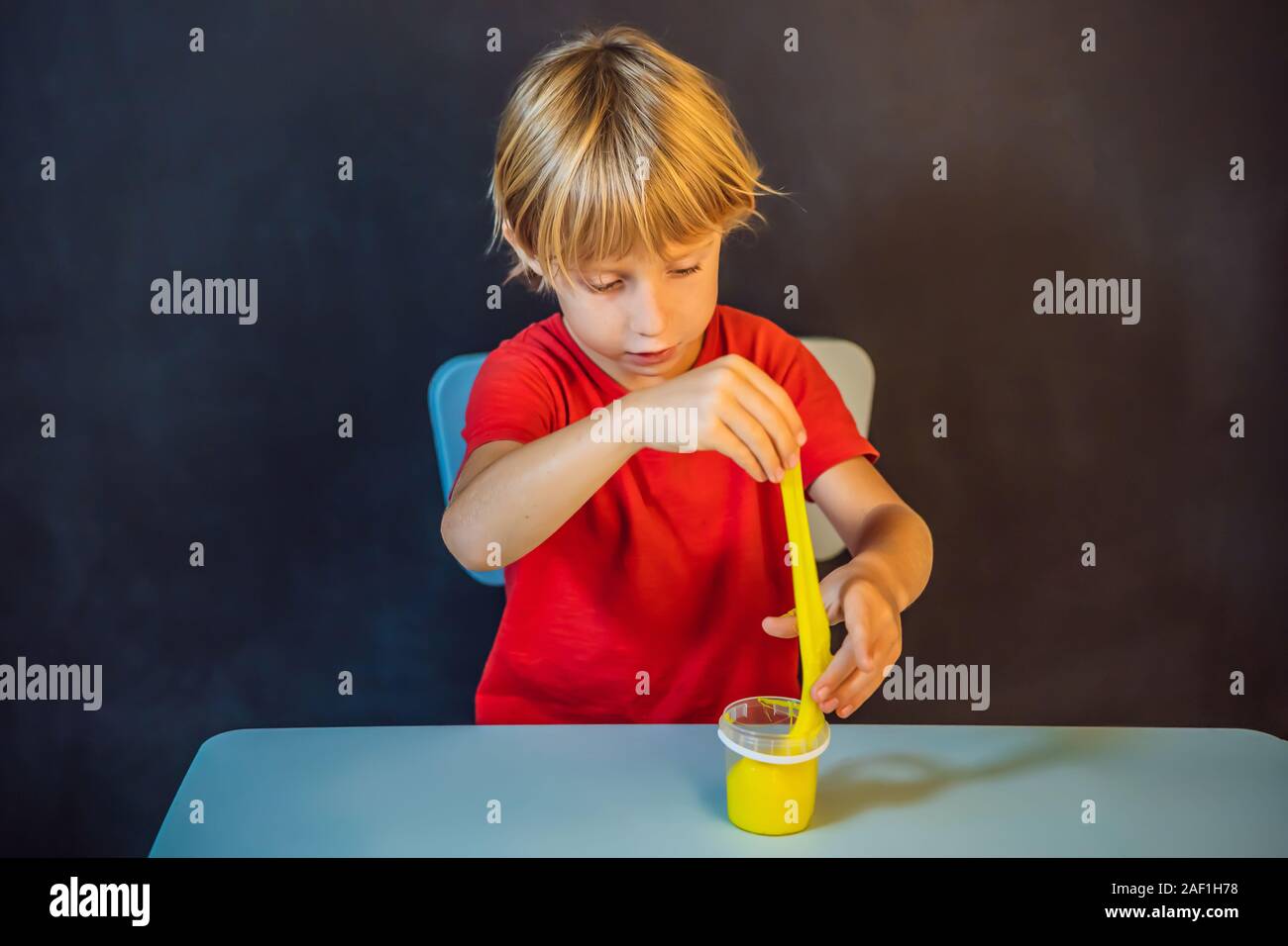 Boy playing hand made toy called slime. Child play with slime. Kid ...