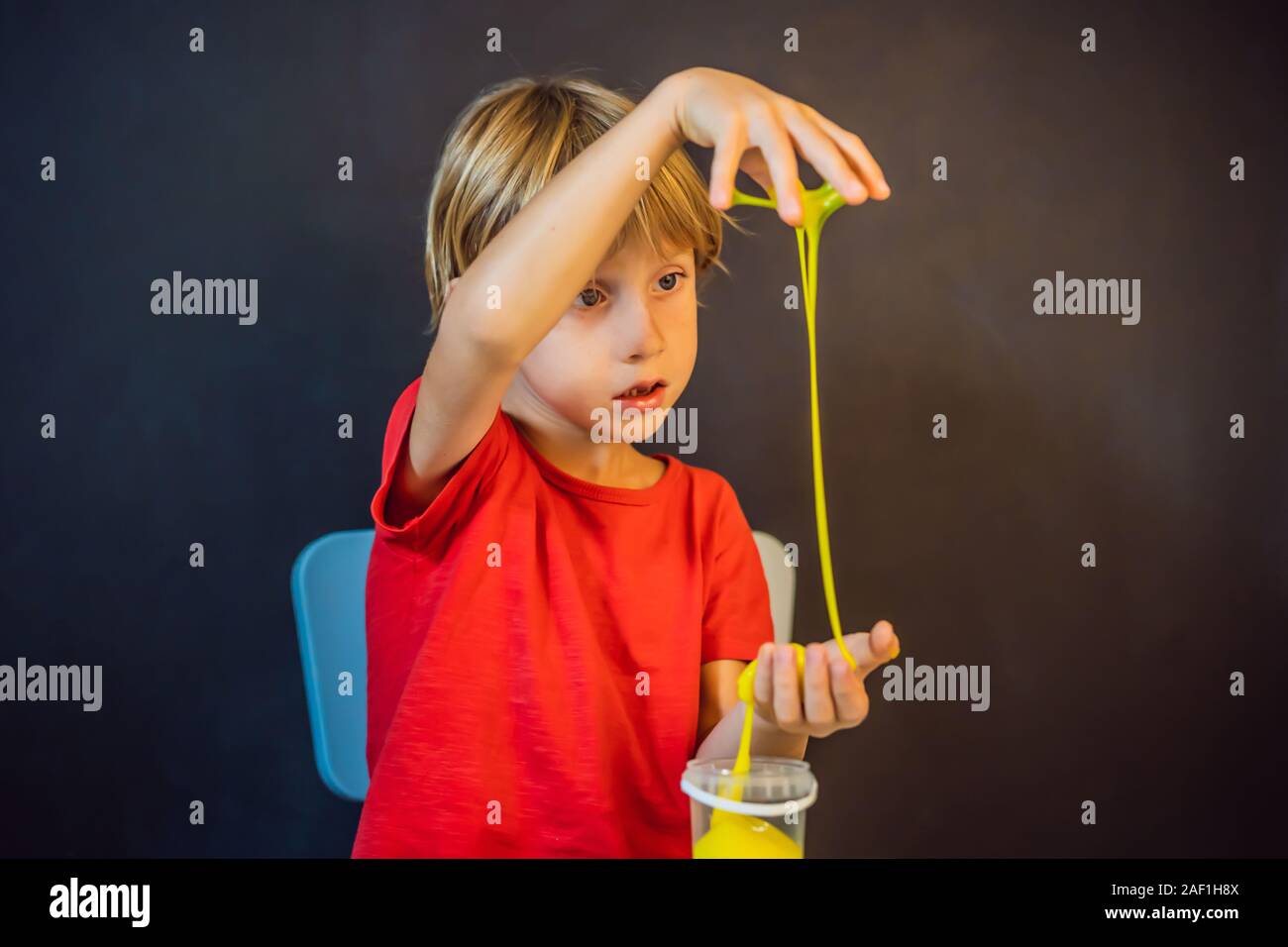 Boy playing hand made toy called slime. Child play with slime. Kid ...