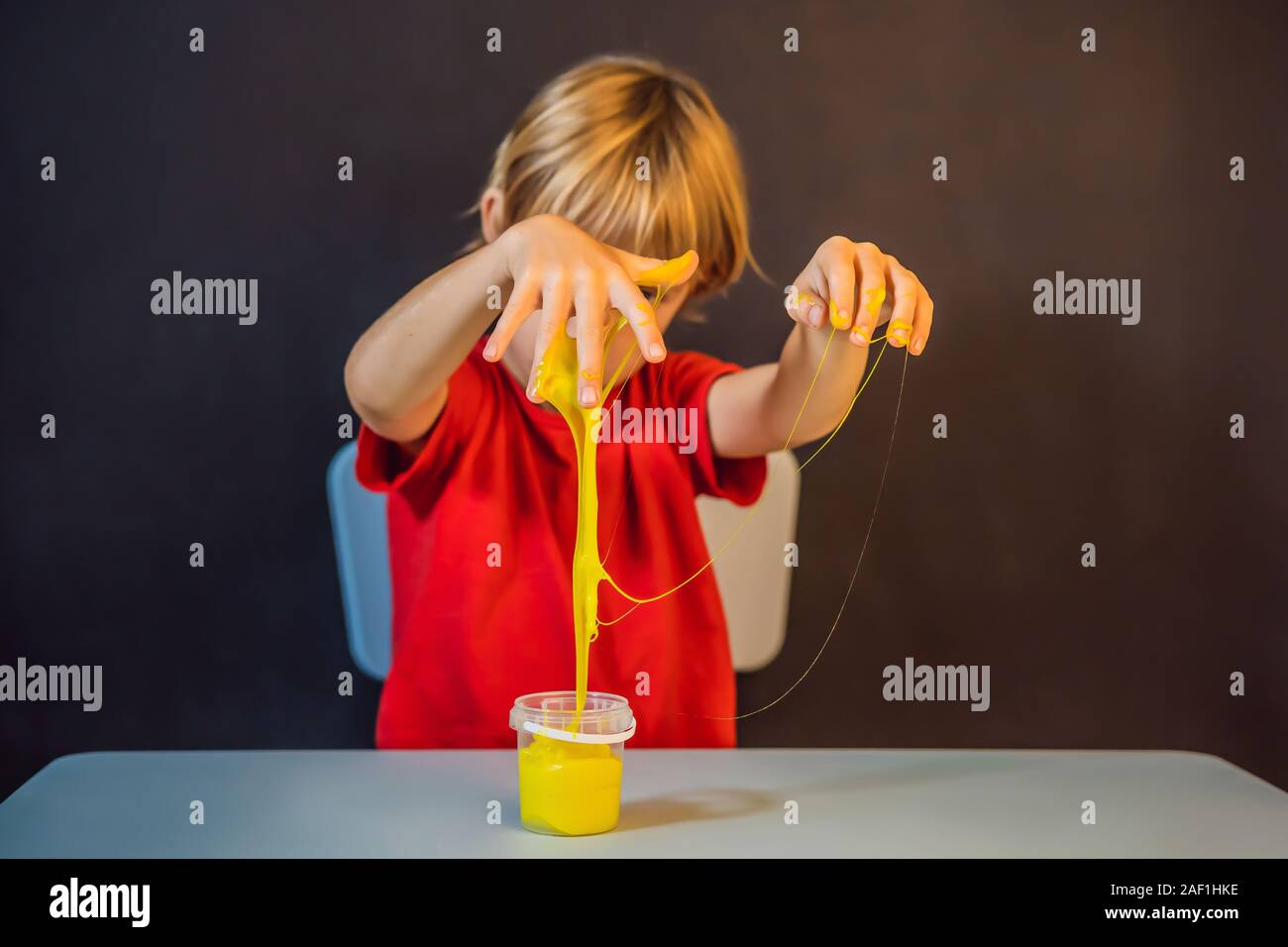 Boy playing hand made toy called slime. Child play with slime. Kid ...