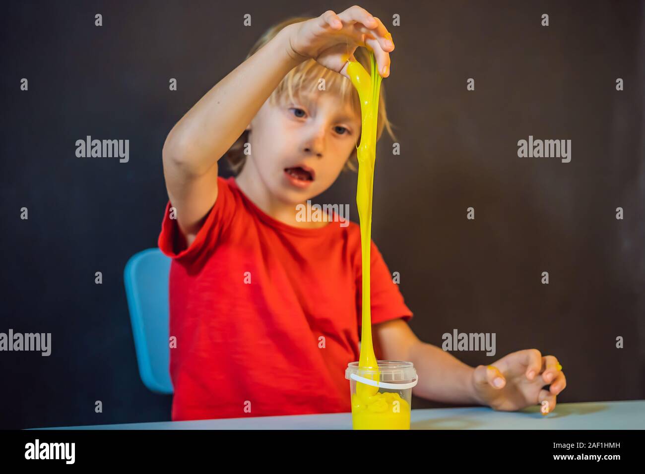 Boy playing hand made toy called slime. Child play with slime. Kid ...