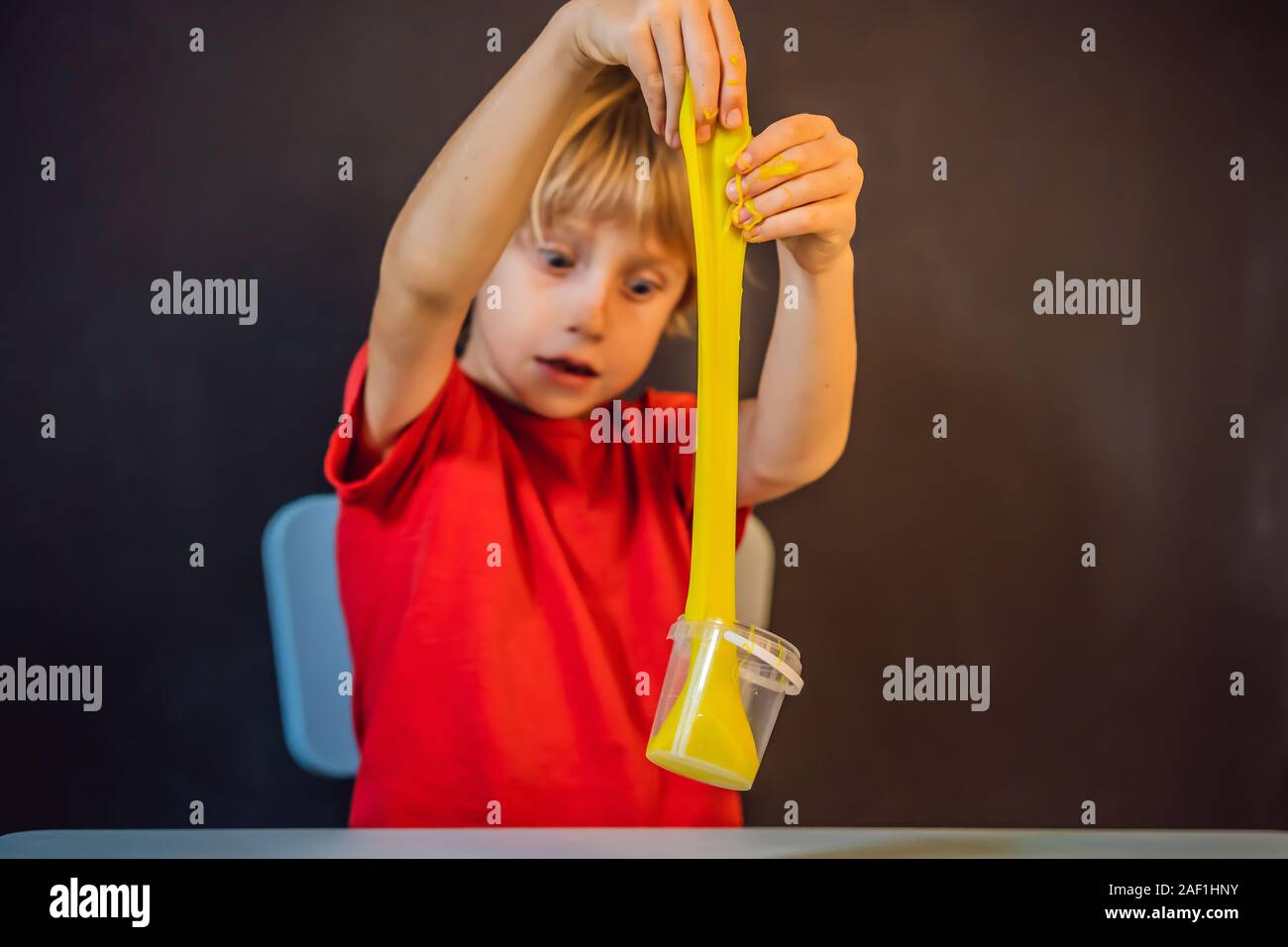 Boy playing hand made toy called slime. Child play with slime. Kid ...