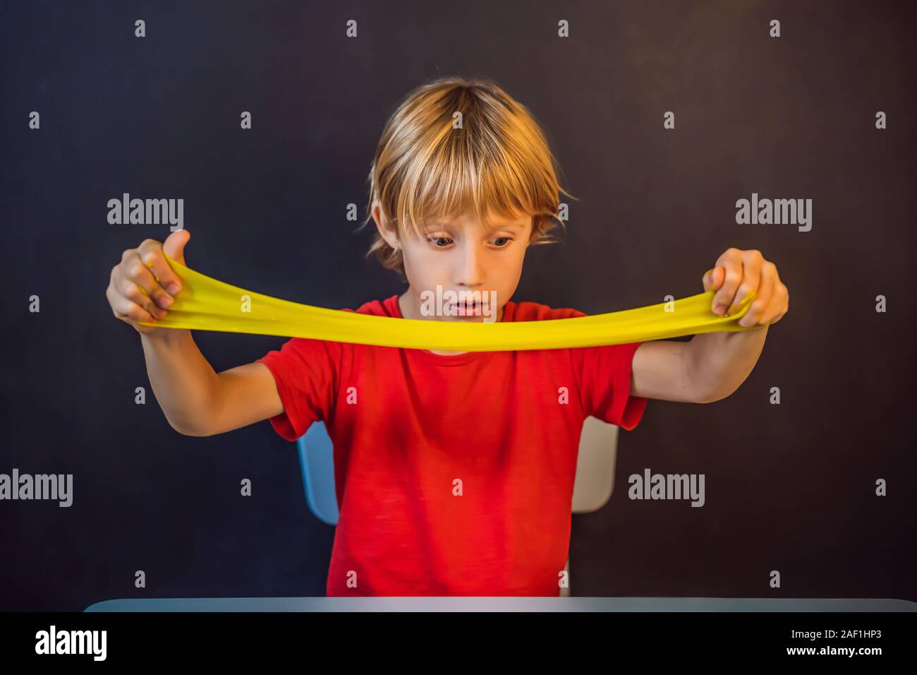 Boy playing hand made toy called slime. Child play with slime. Kid ...