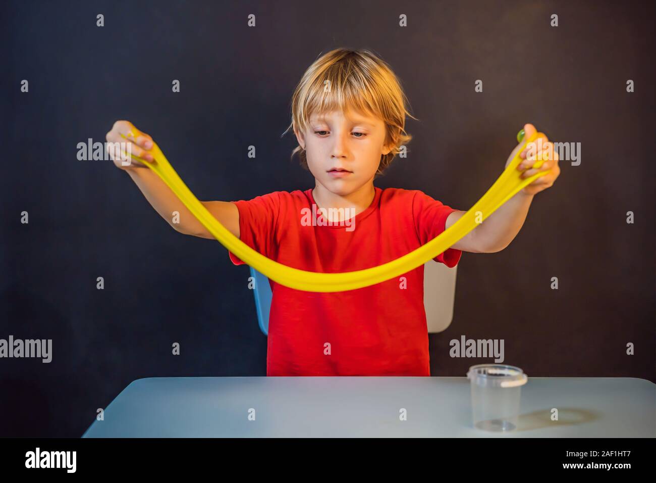 Boy playing hand made toy called slime. Child play with slime. Kid ...