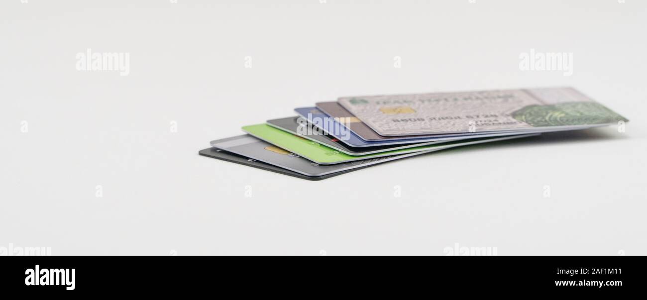 Stack of multi-colored credit cards on a white background. Isolated ...