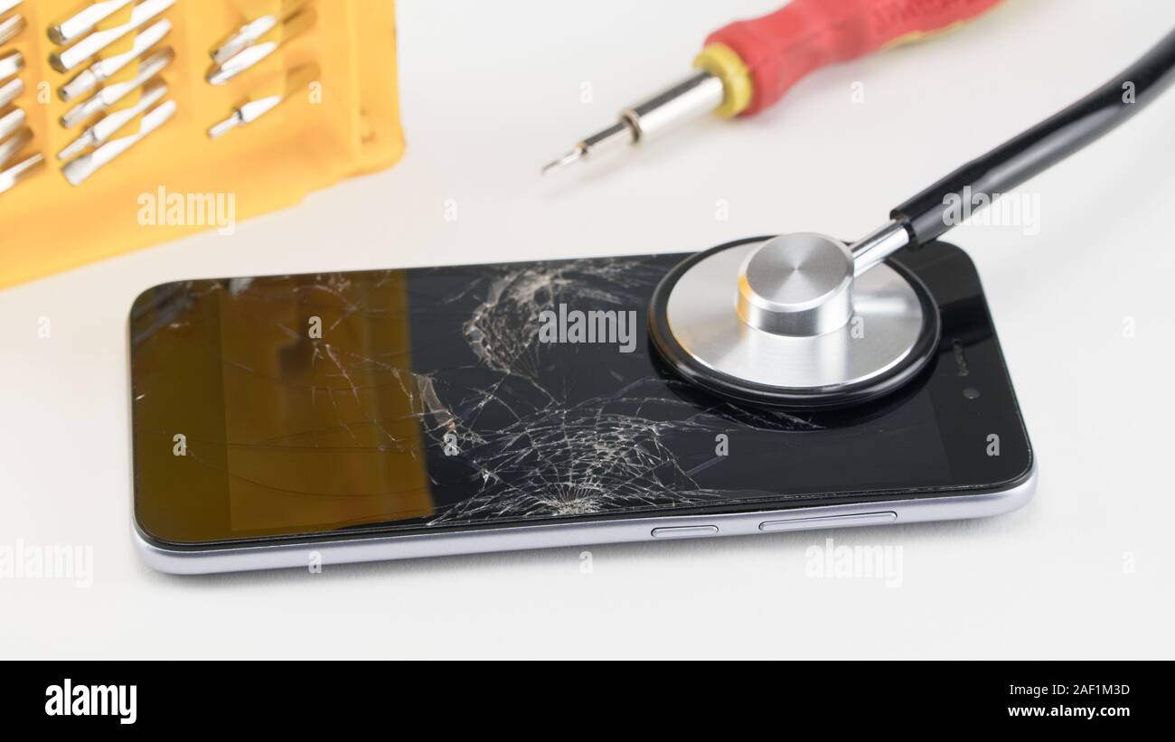 Diagnosing the phone with a stethoscope, near a screwdriver. Phone ...