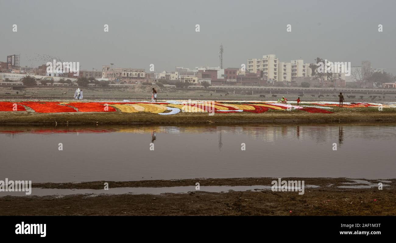 Agra, India - Nov 12, 2017. People washing and drying colorful sarees ...