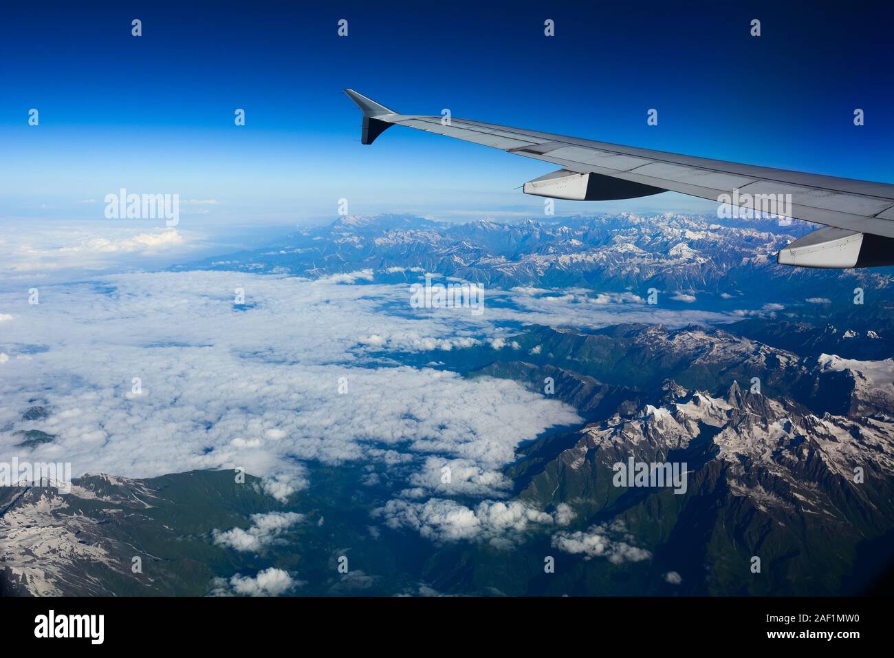 View from airplane window to Hymalaya Mountains and clouds. Travel to ...