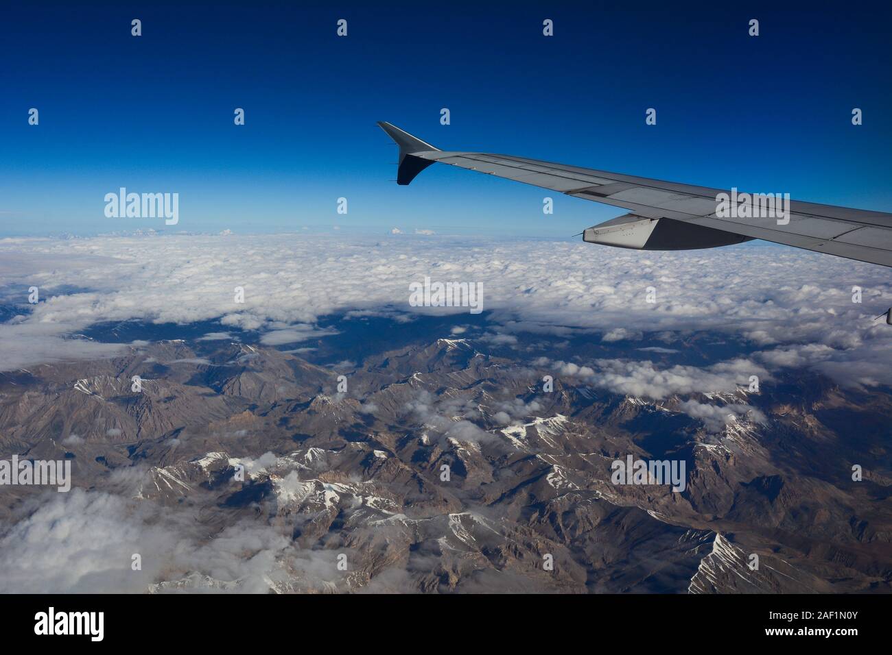 View from airplane window to Hymalaya Mountains and clouds. Travel to ...