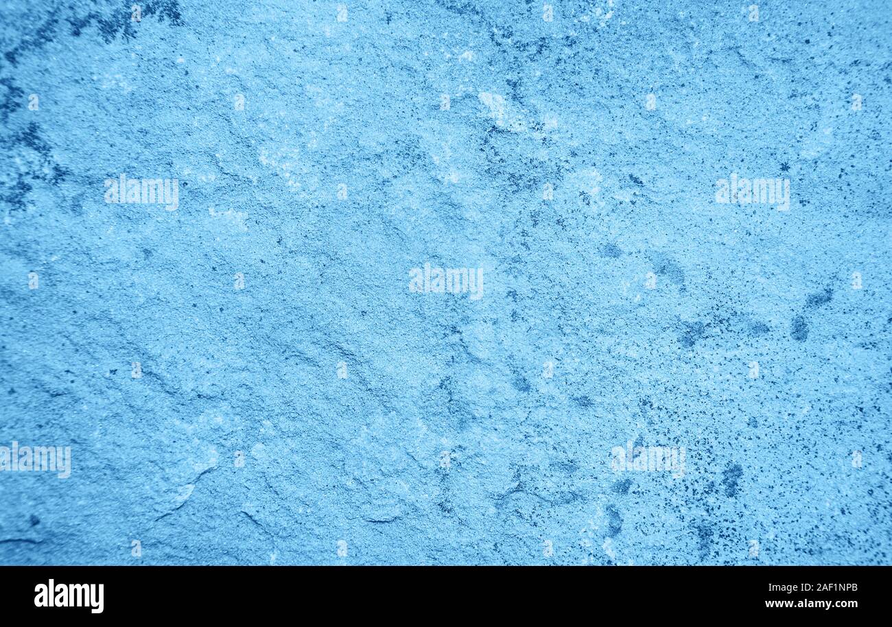 Ancient stone wall, background or texture toned classic blue color ...