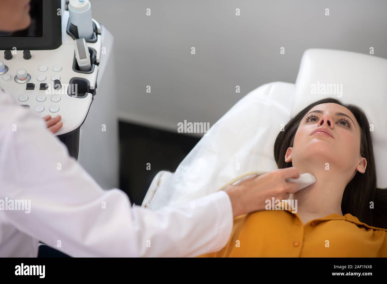 Female doctor making ultrasound thyroid gland test Stock Photo - Alamy