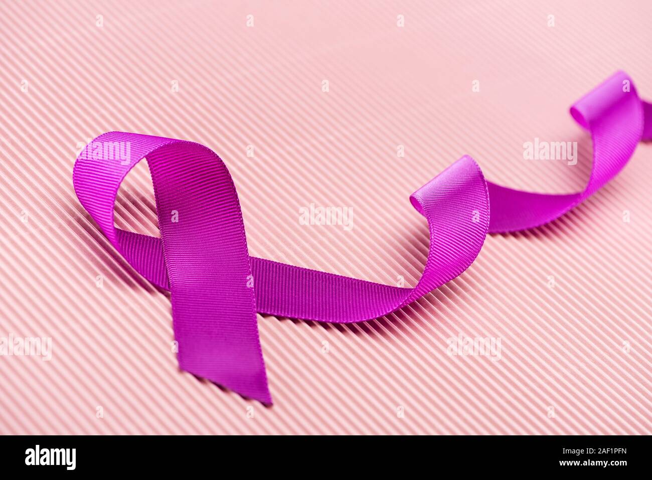 purple ribbon on pink background, violence concept Stock Photo - Alamy