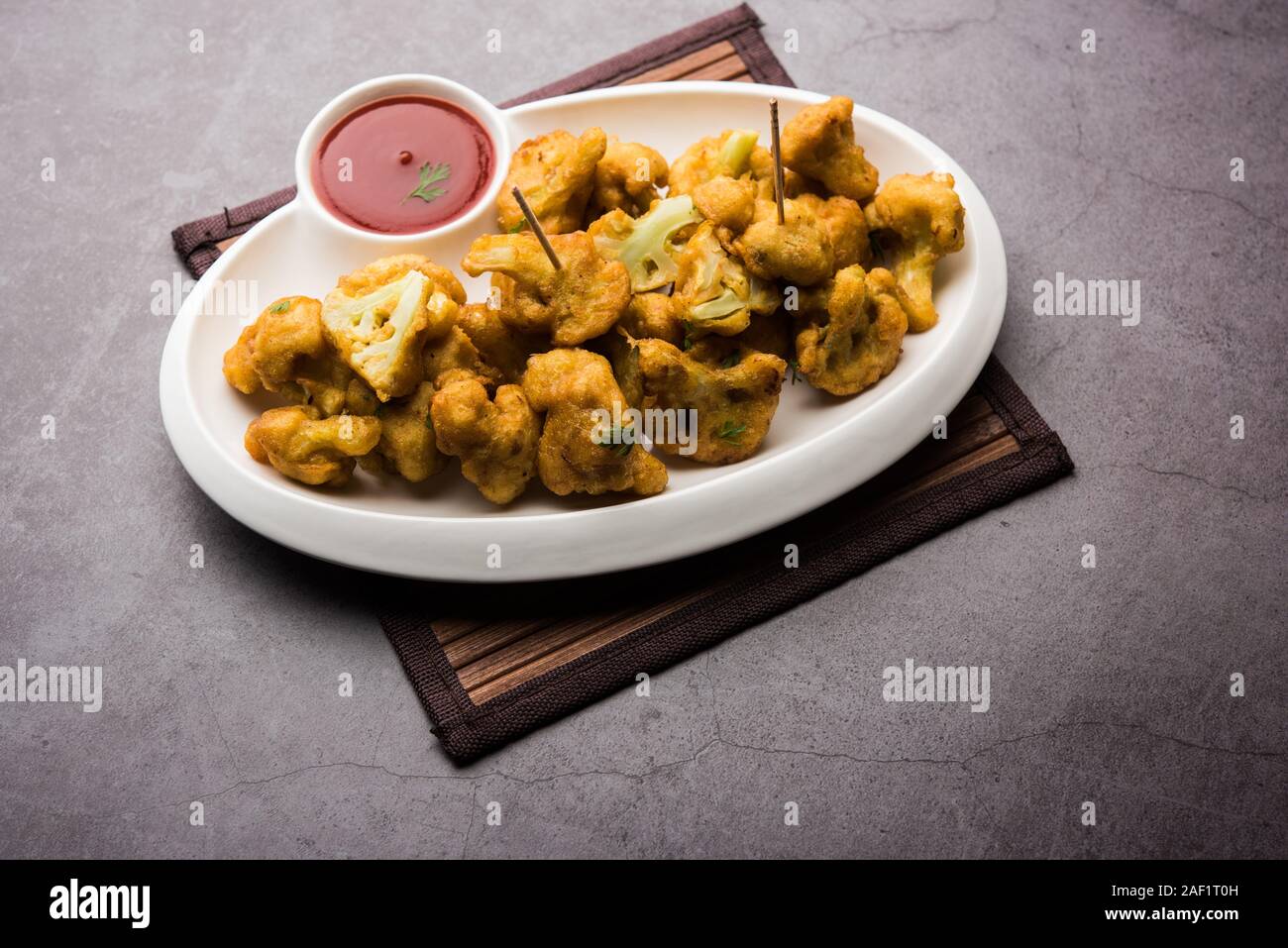 Gobi pakora or Phoolgobi pakoda made using fresh cauliflower dipped ...