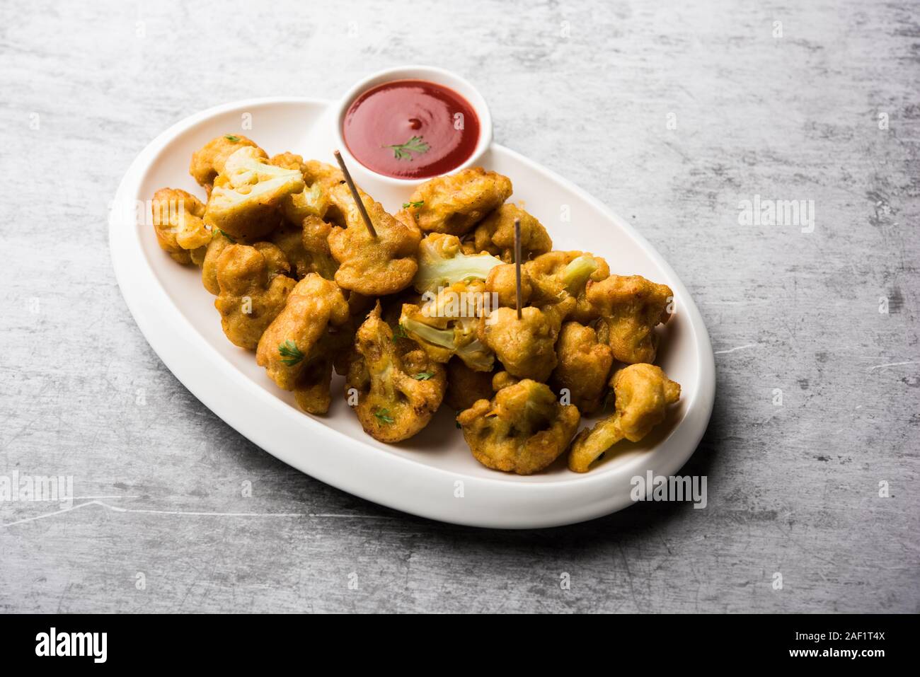 Gobi pakora or Phoolgobi pakoda made using fresh cauliflower dipped ...