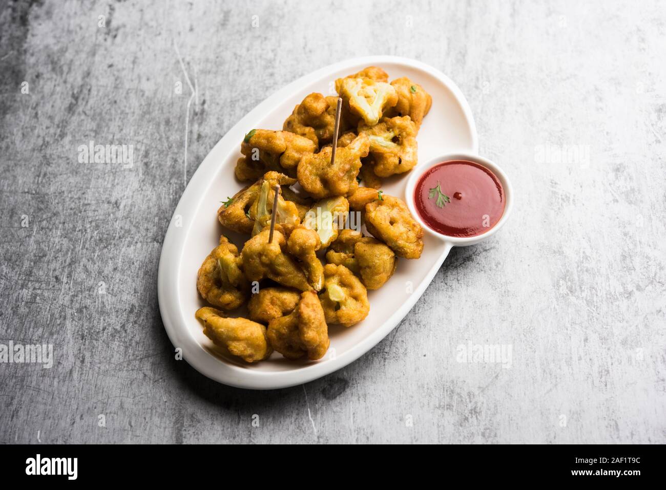 Gobi pakora or Phoolgobi pakoda made using fresh cauliflower dipped ...
