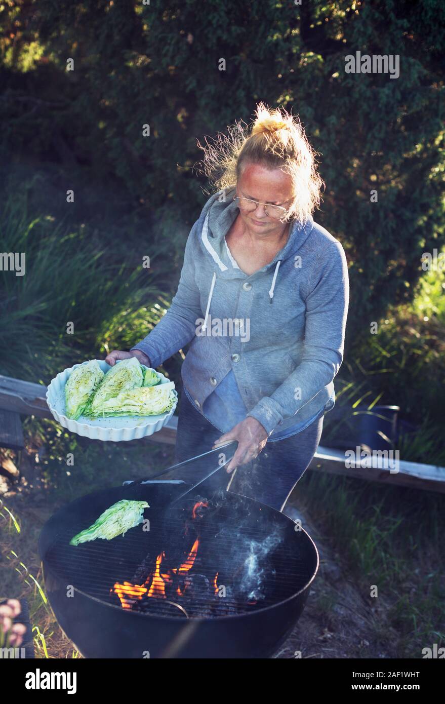 Woman having barbecue Stock Photo - Alamy