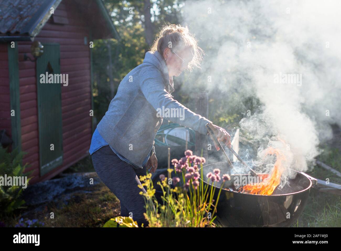 Woman having barbecue Stock Photo - Alamy