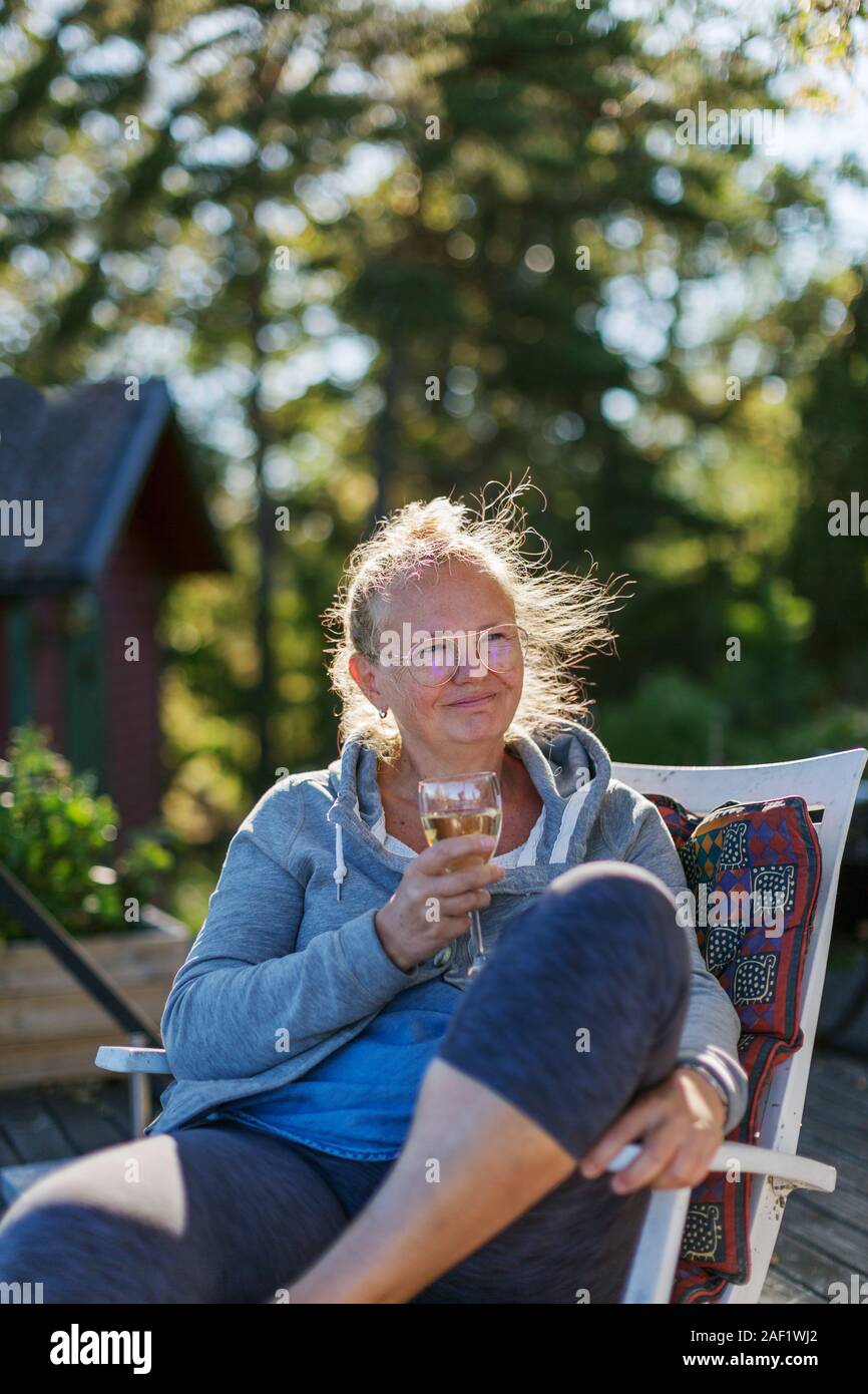 Woman relaxing with glass of wine Stock Photo - Alamy