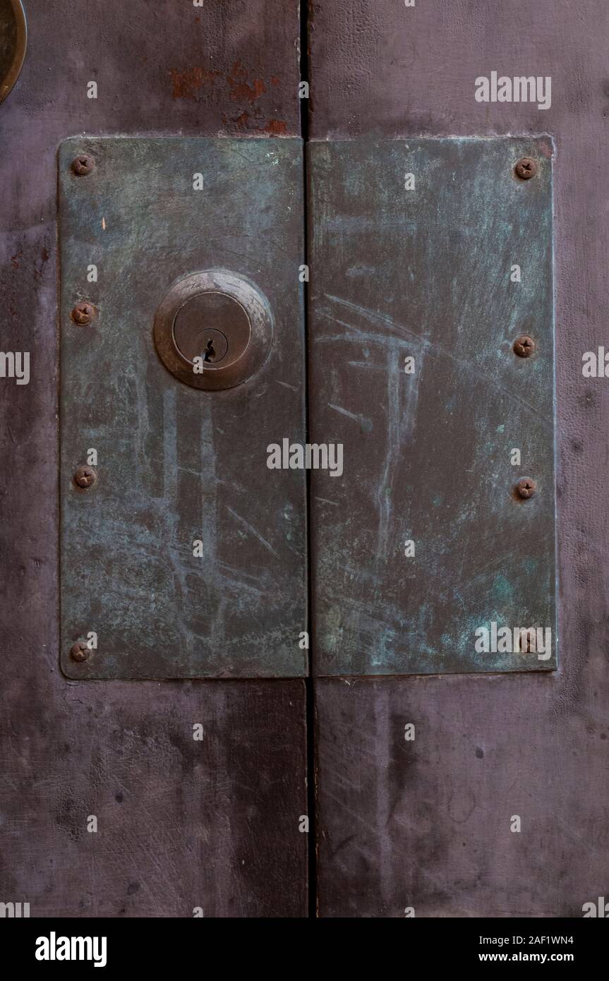 Old door lock with large metal plate on purple wood door Stock Photo ...